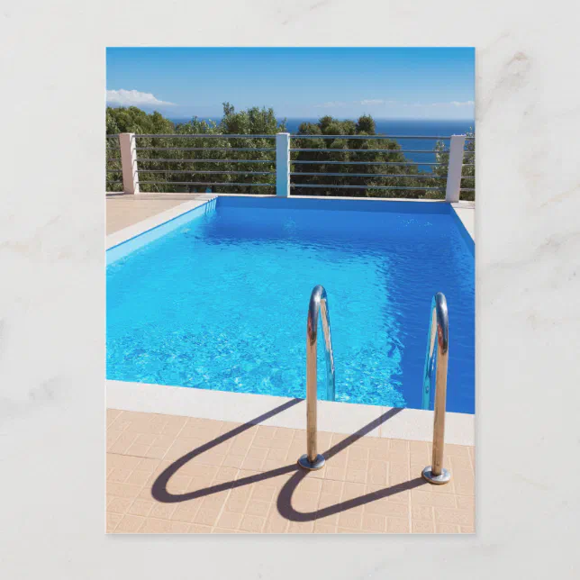 Blue swimming pool with steps at sea postcard | Zazzle