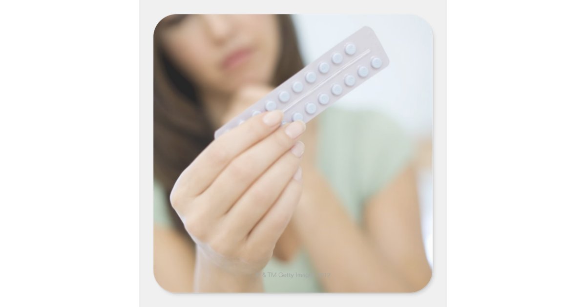 Contraceptive pills in a woman's hand. square sticker | Zazzle