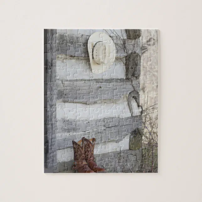 Cowboy boots and hat outside of log cabin jigsaw puzzle | Zazzle