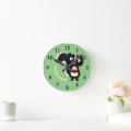 Cute happy skunk cartoon illustration round clock | Zazzle