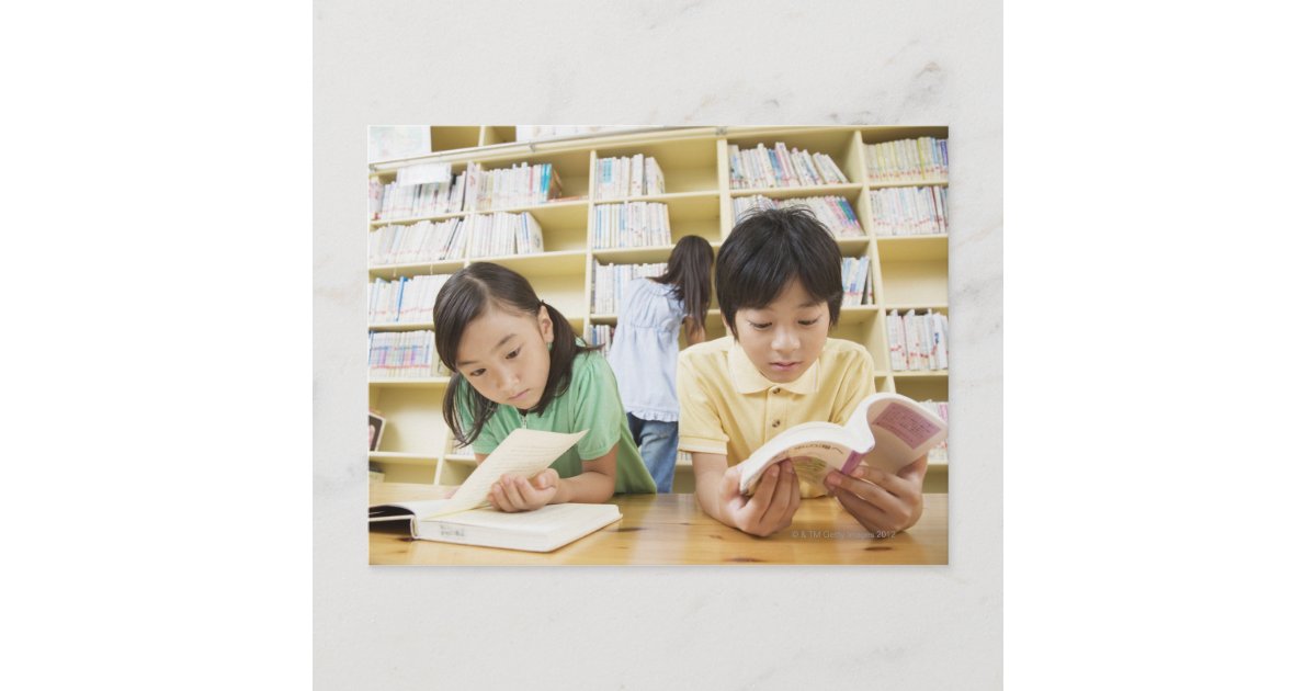 Elementary school students reading a book postcard | Zazzle