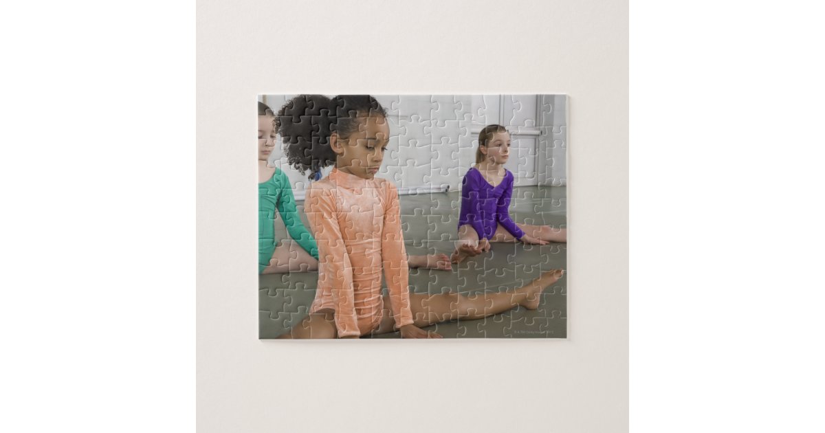 Girls stretching in gymnastics practice jigsaw puzzle | Zazzle