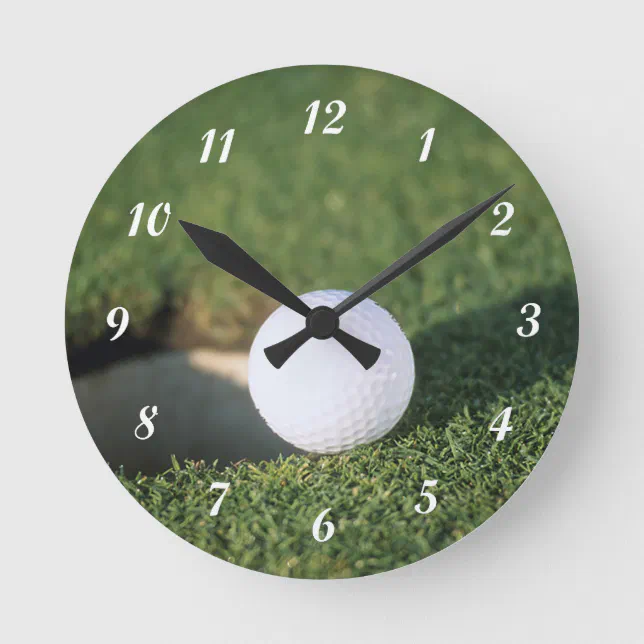 Golf Ball on the edge of hole Round Clock | Zazzle