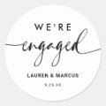 Modern Minimalist Script We're Engaged Classic Round Sticker | Zazzle