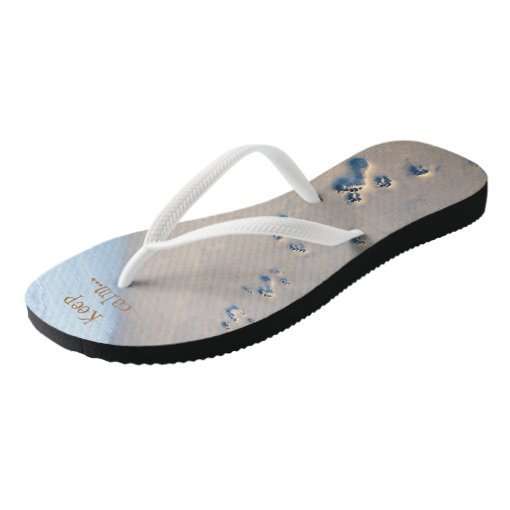 Paw prints and footprints in the sand flip flops | Zazzle