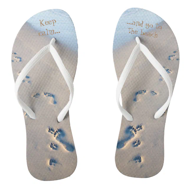 Paw prints and footprints in the sand flip flops | Zazzle
