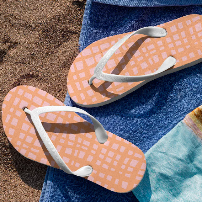 Retro pastel orange and pink grid pattern flip flops | Zazzle