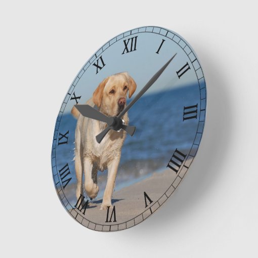 Yellow labrador retriever on the beach round clock | Zazzle