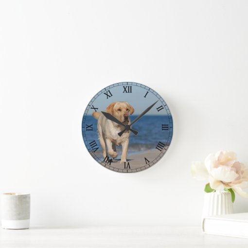 Yellow labrador retriever on the beach round clock | Zazzle